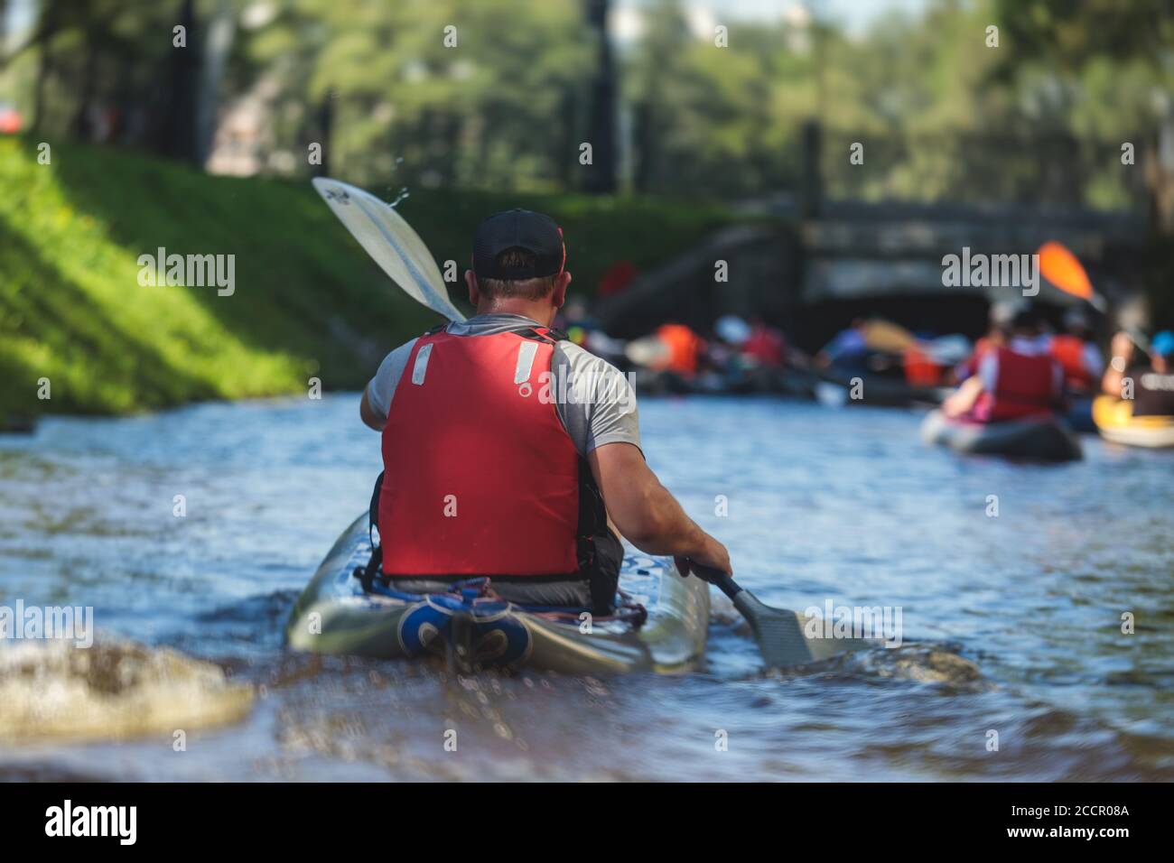 A process of kayaking in the city river canals, with colorful canoe ...