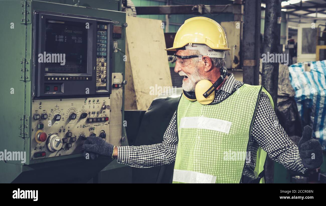 Smart factory worker using machine in factory workshop Stock Photo - Alamy