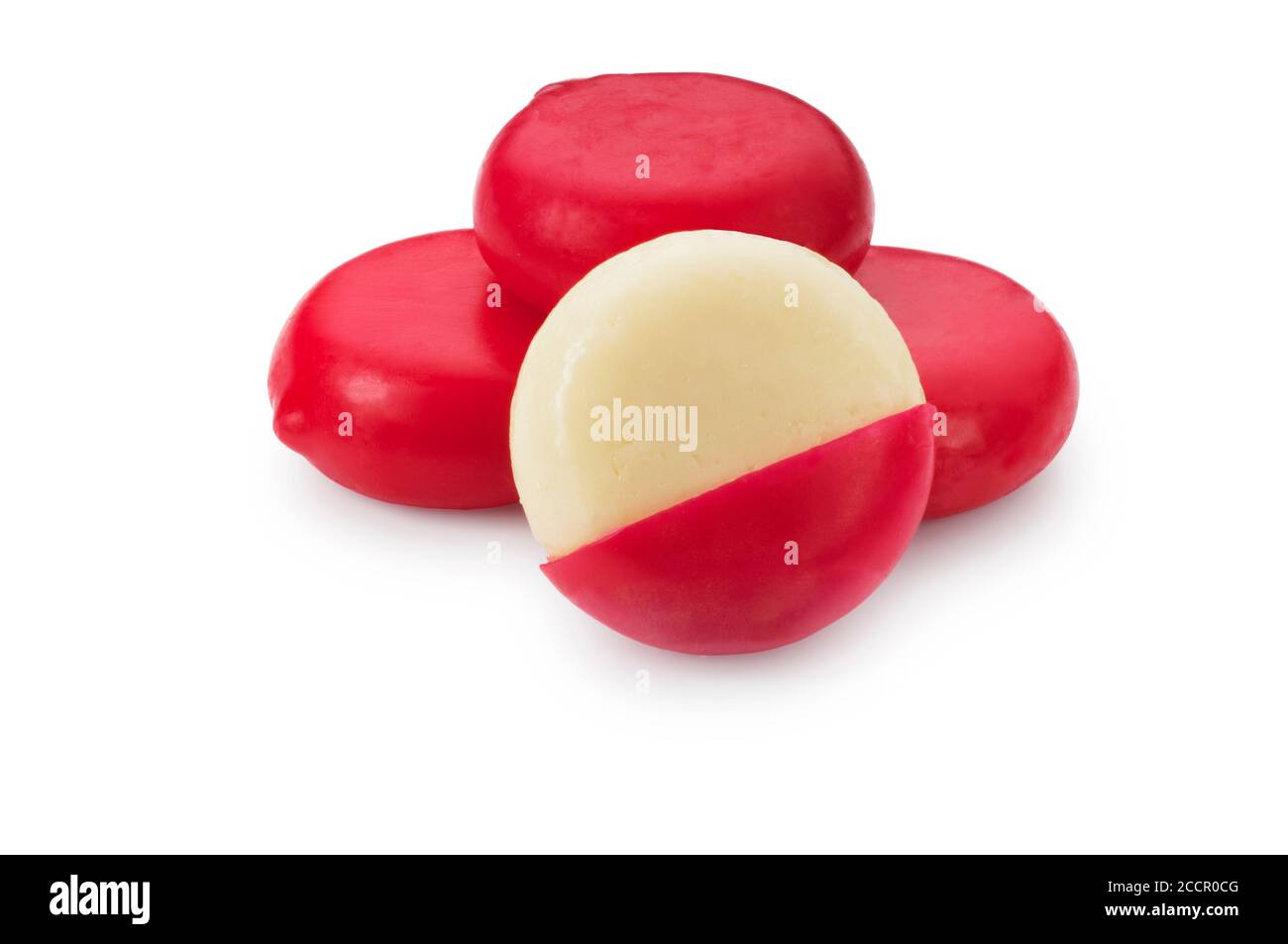Studio shot of small red edam cheese cut out against a white background ...