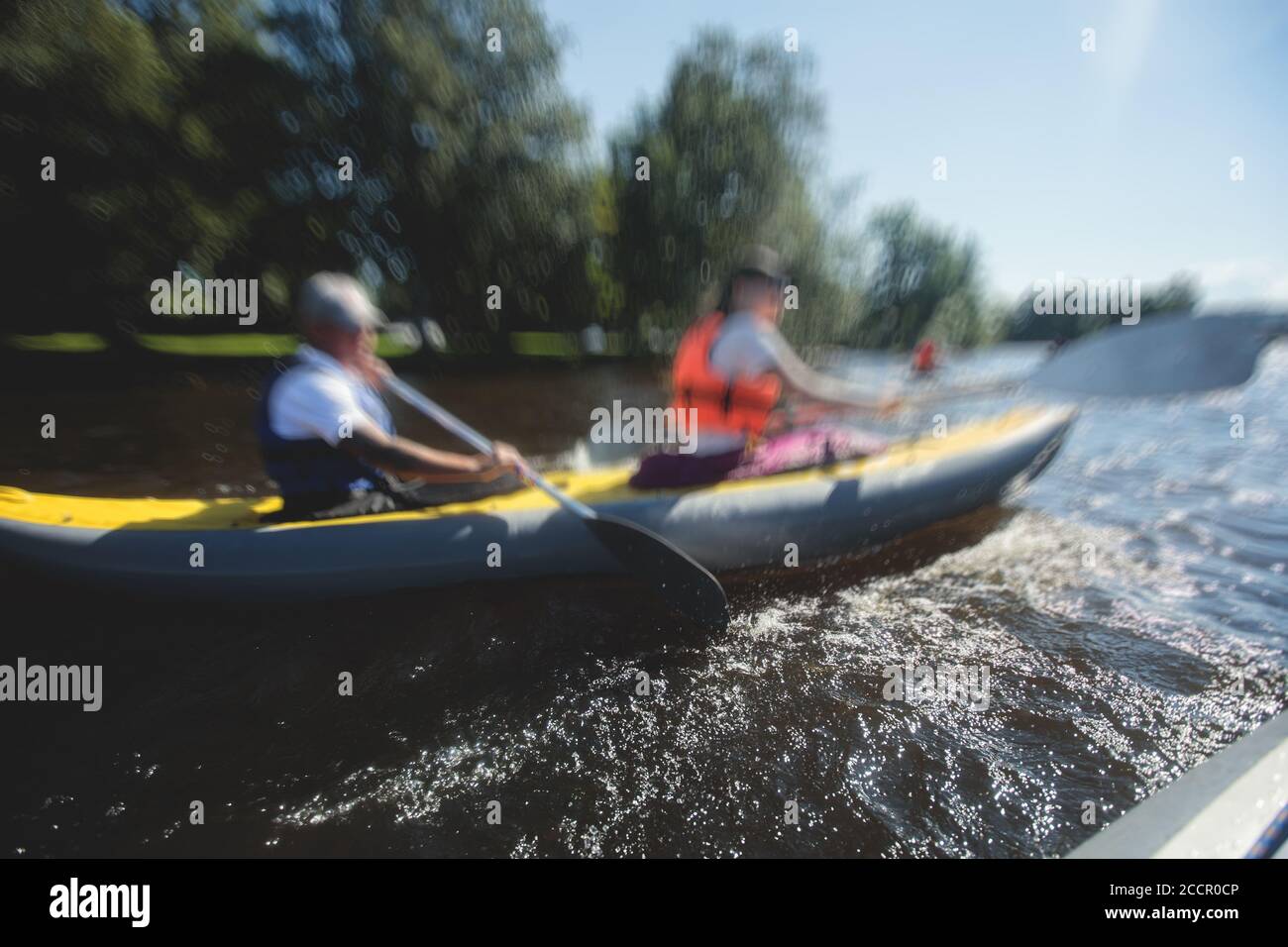 A process of kayaking in the city river canals, with colorful canoe ...