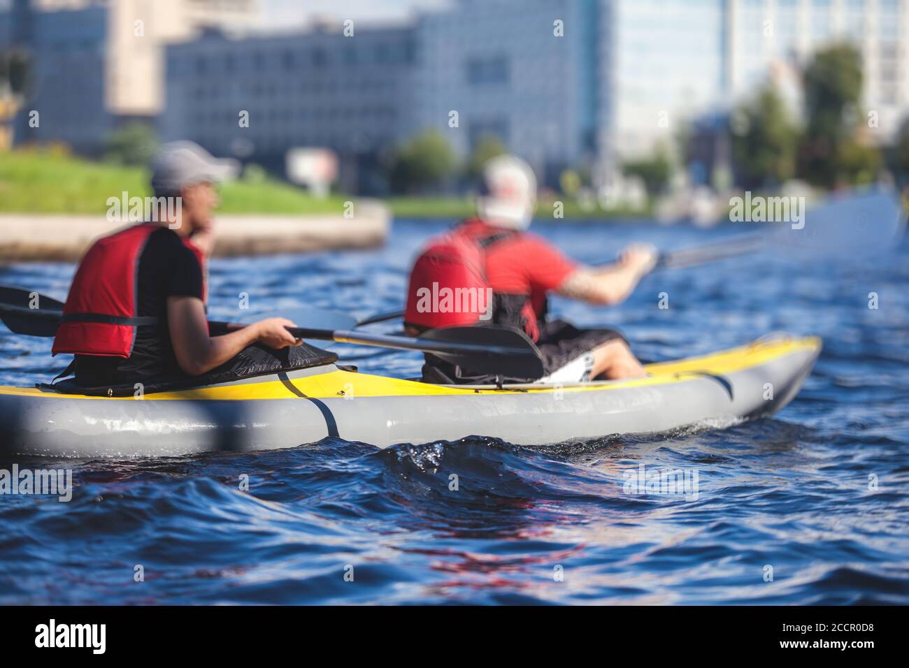 A process of kayaking in the city river canals, with colorful canoe ...