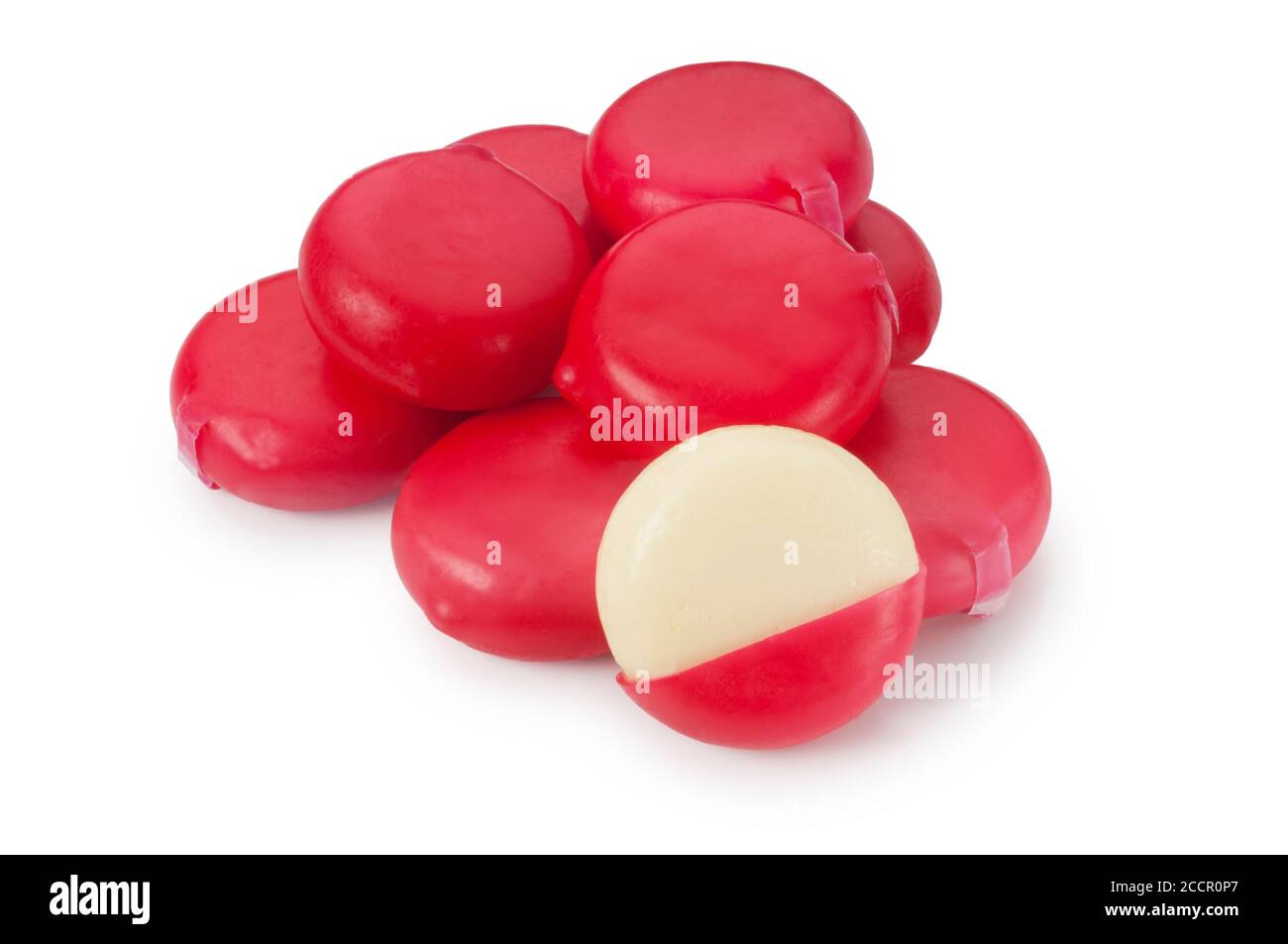 Studio shot of small red edam cheese cut out against a white background ...