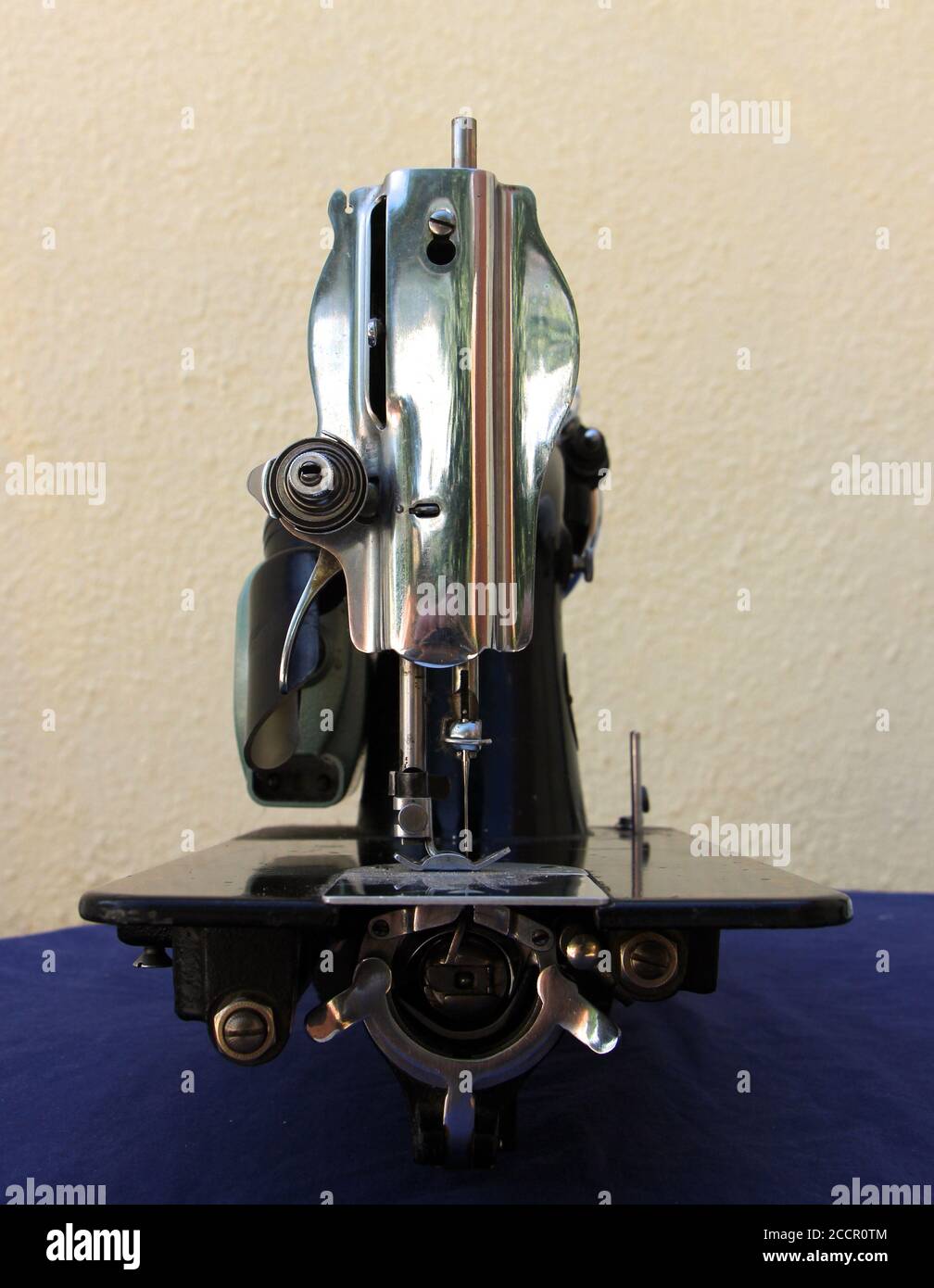Old Alfa electric sewing machine black painted on a blue cloth ...