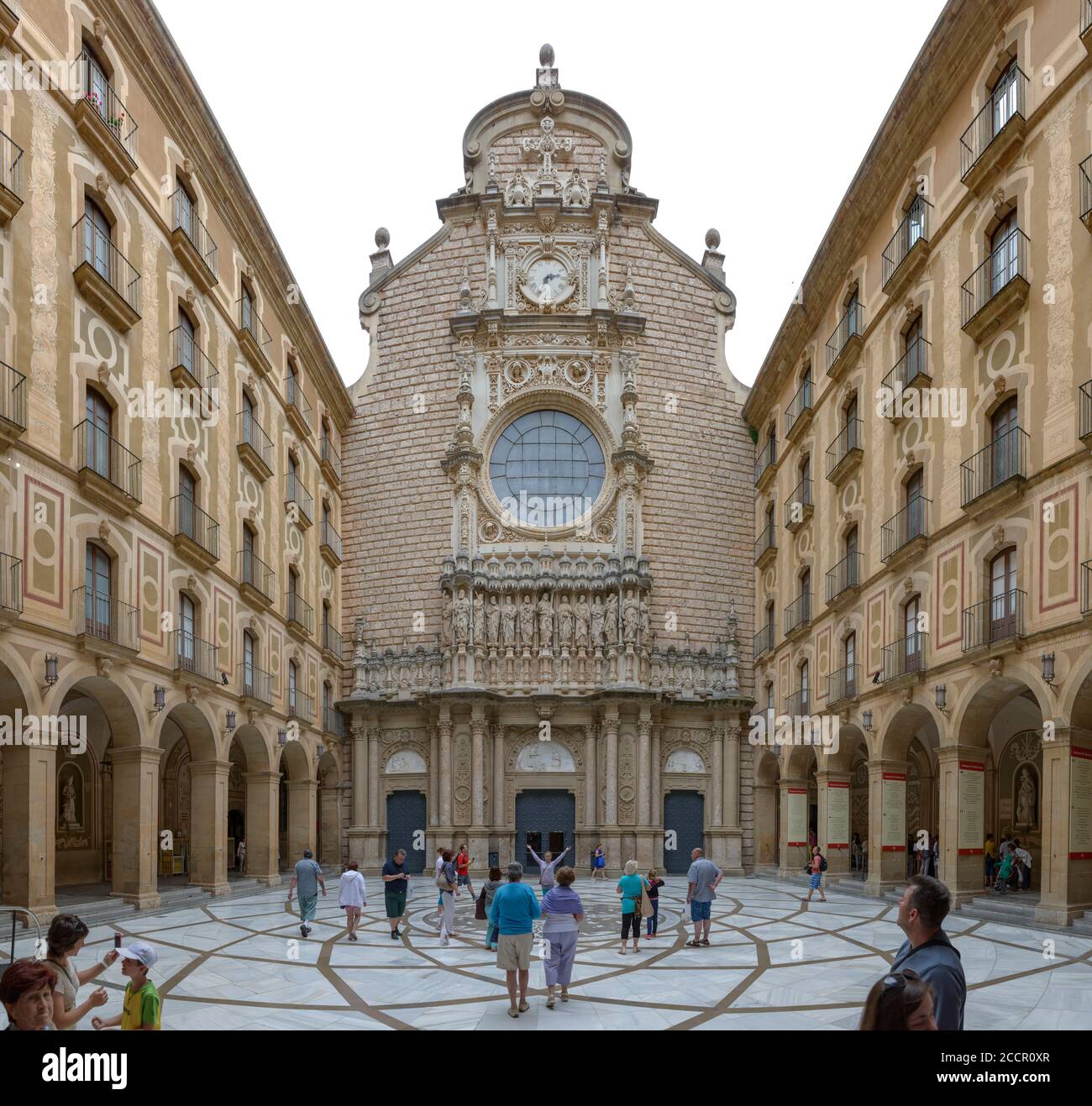 Roofless courtyard in front Basilica of Montserrat abbey facade ...