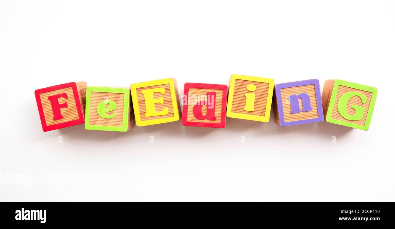 Feeding word made from colourful wooden baby development blocks Stock ...