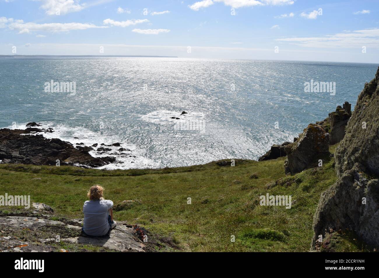 Seated figure looking to sea hi-res stock photography and images - Alamy