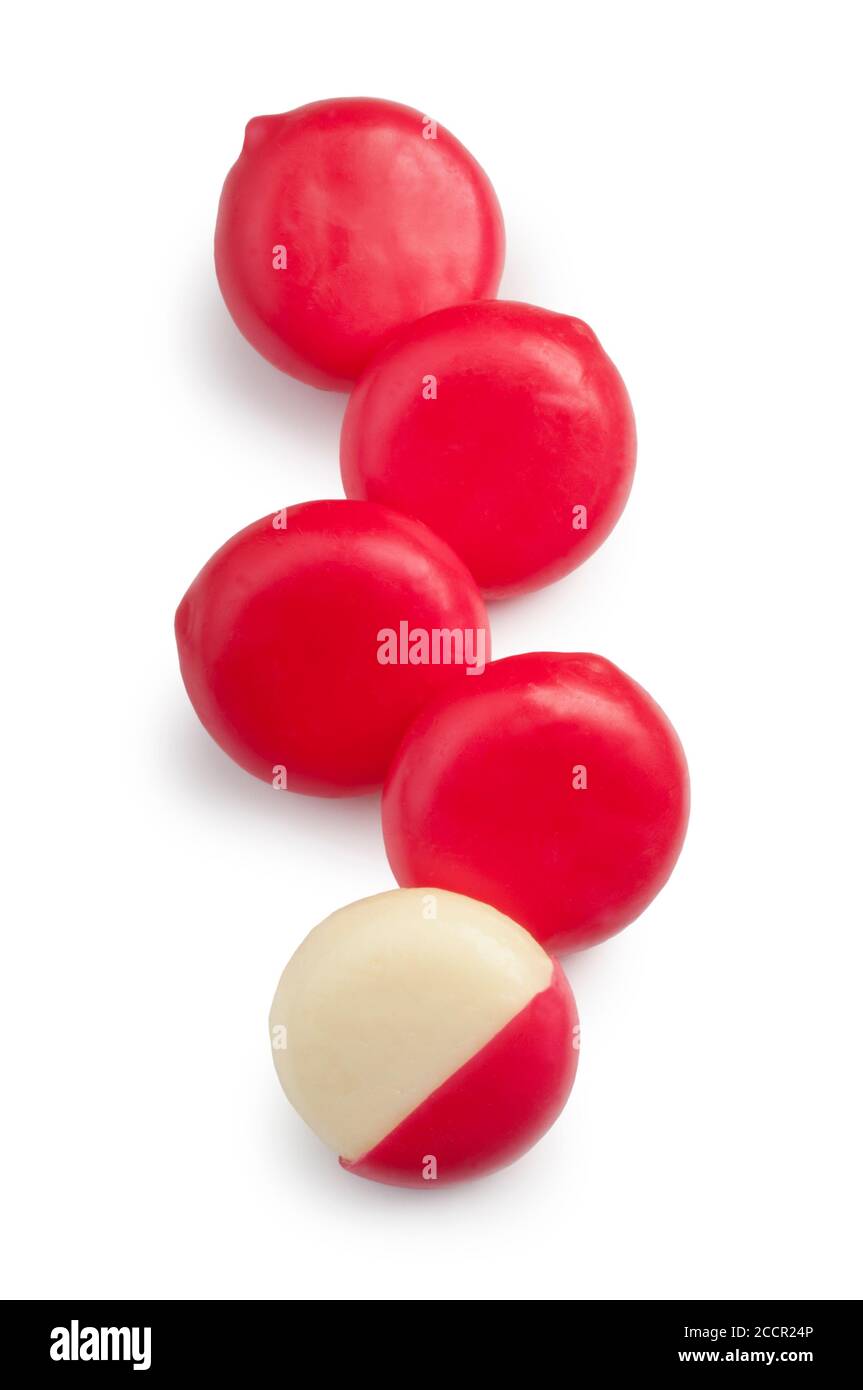 Studio shot of small red edam cheese cut out against a white background ...