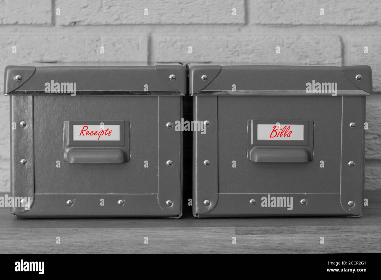 Storage boxes with receipts and bills written on labels in red. With a ...