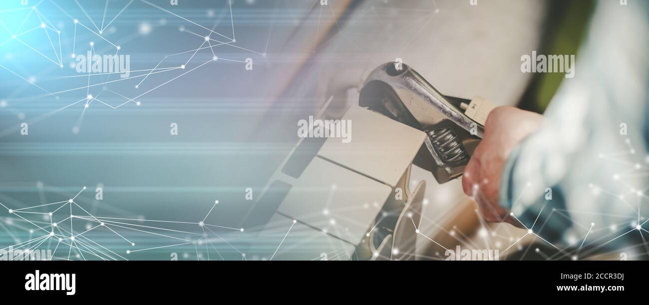 Repairman working on radiator with wrench; panoramic banner Stock Photo ...