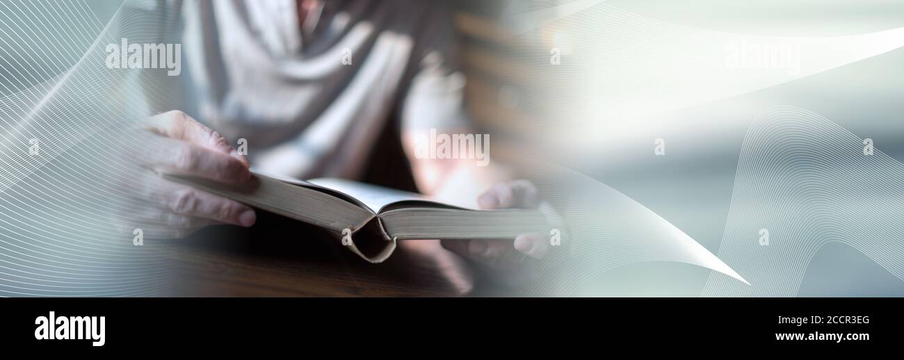 Man sitting at a table reading a book. panoramic banner Stock Photo - Alamy