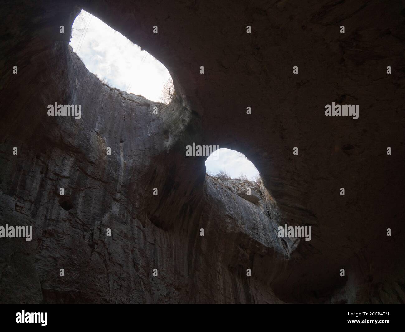 Openings in a cave eyes like Stock Photo - Alamy