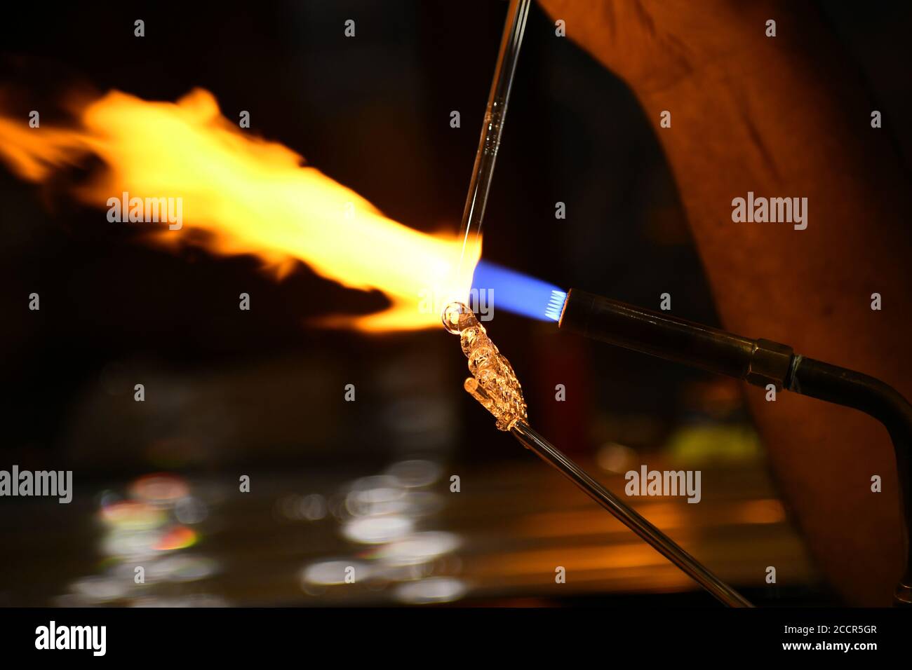 Closeup shot of a burning fire flame from the machine in the darkness ...