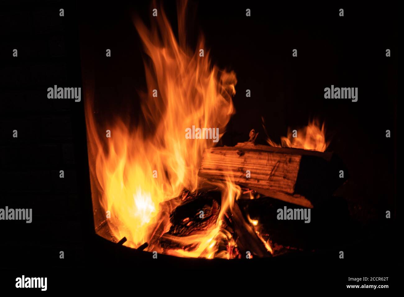 Closeup of fire flames glowing in the dark Stock Photo - Alamy