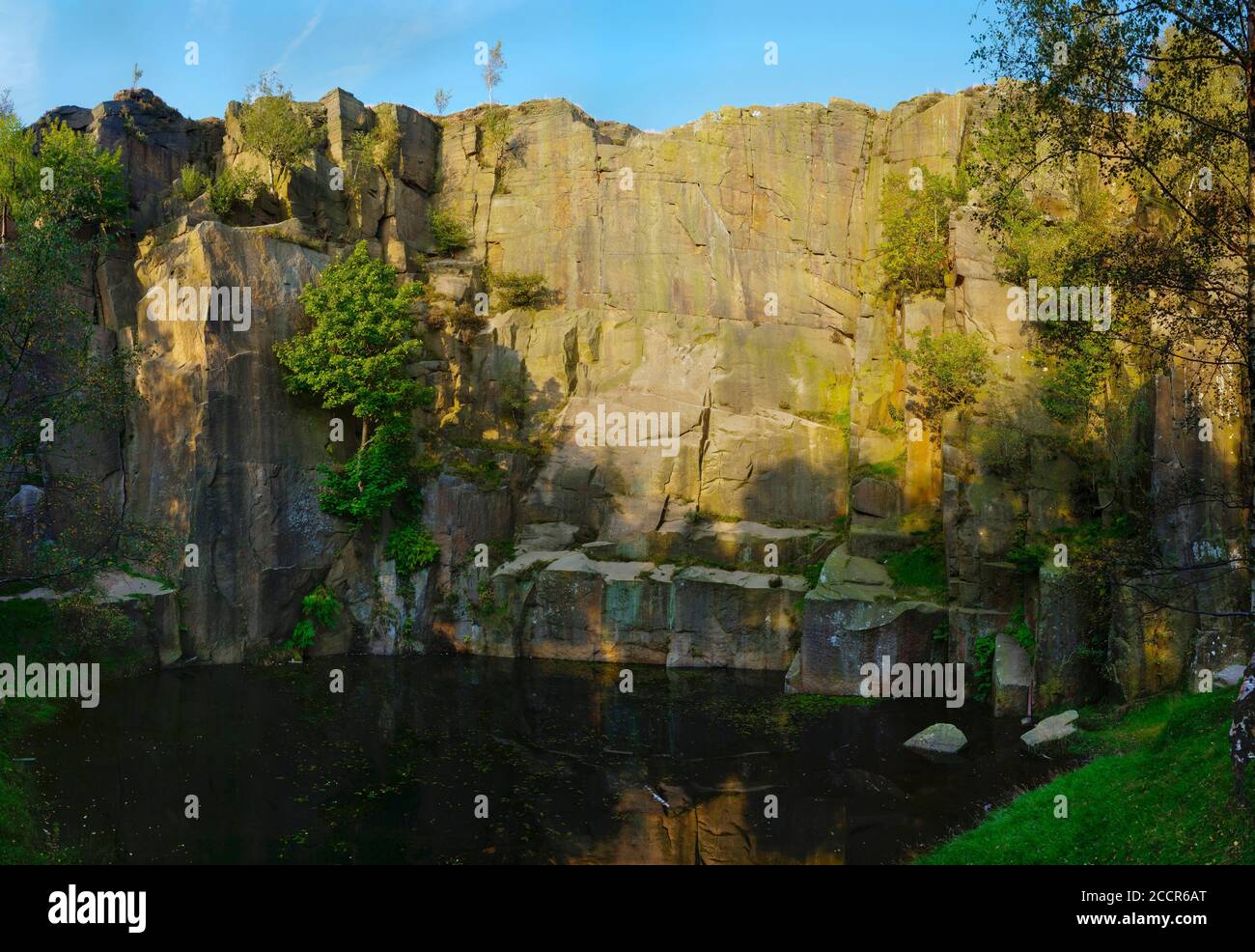 Abandoned gritstone face with a small lake at Bole Hill Quarry, near ...