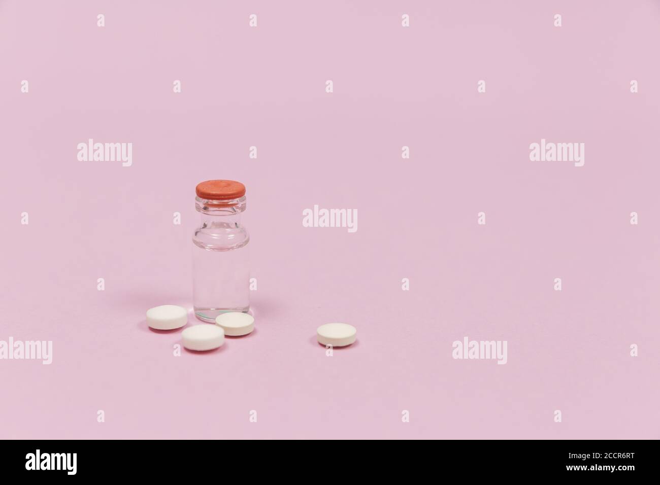 Pill and injection bottle on pink background Stock Photo - Alamy