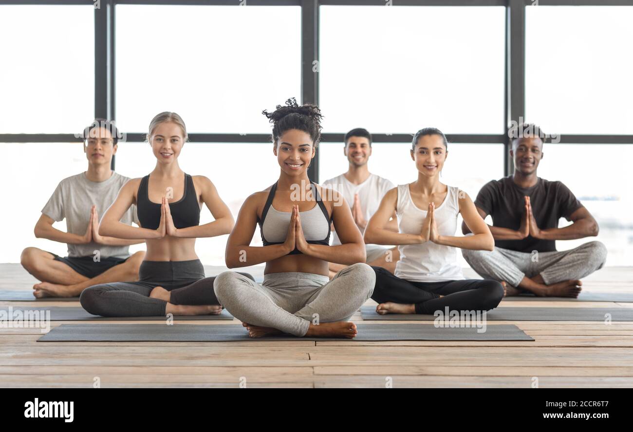 Wellness Concept. Happy Multicultural Young People Practicing Yoga In ...