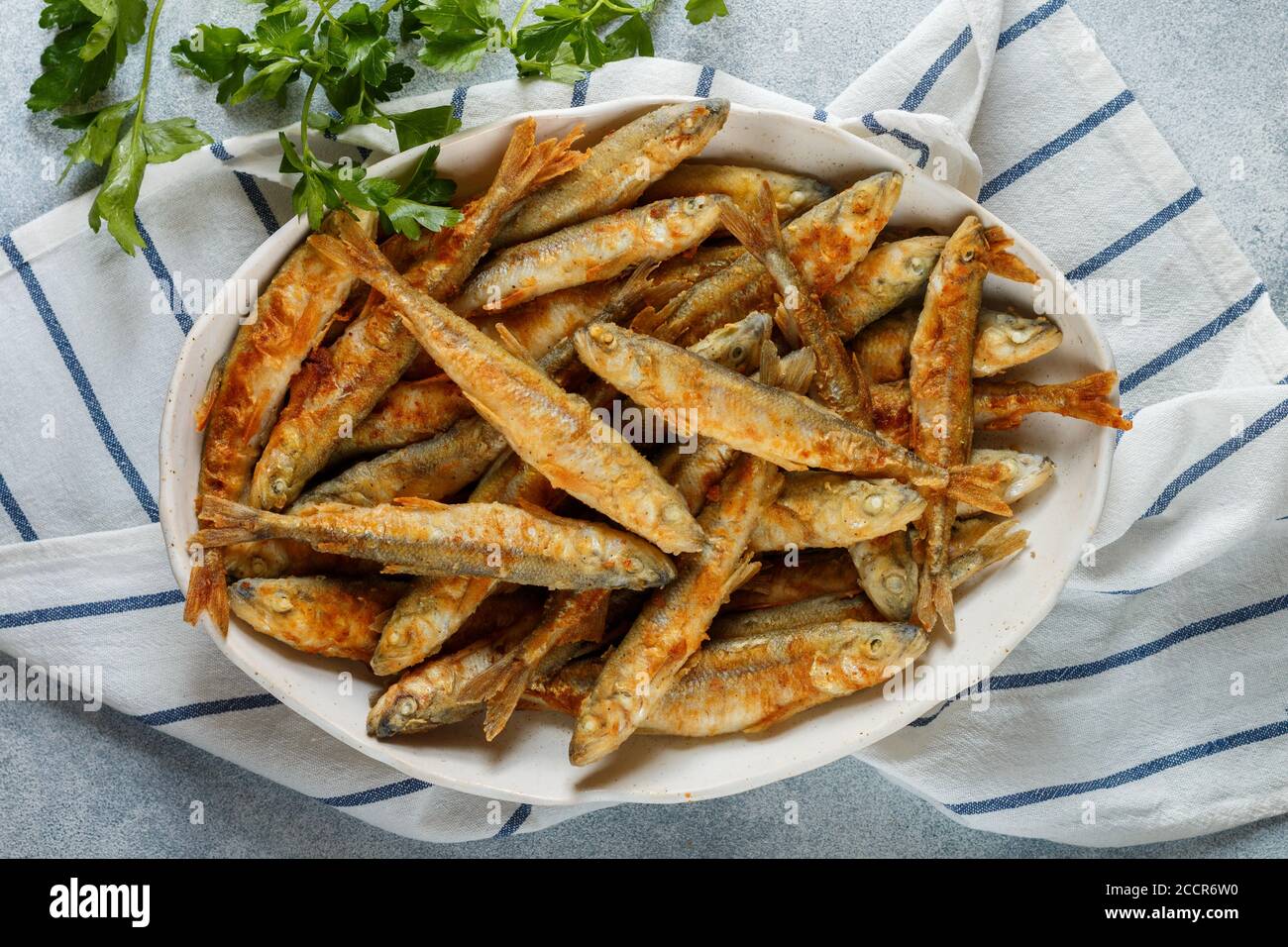 Fried smelt . Delicious small fish in a white plate. Gourmet appetizer ...