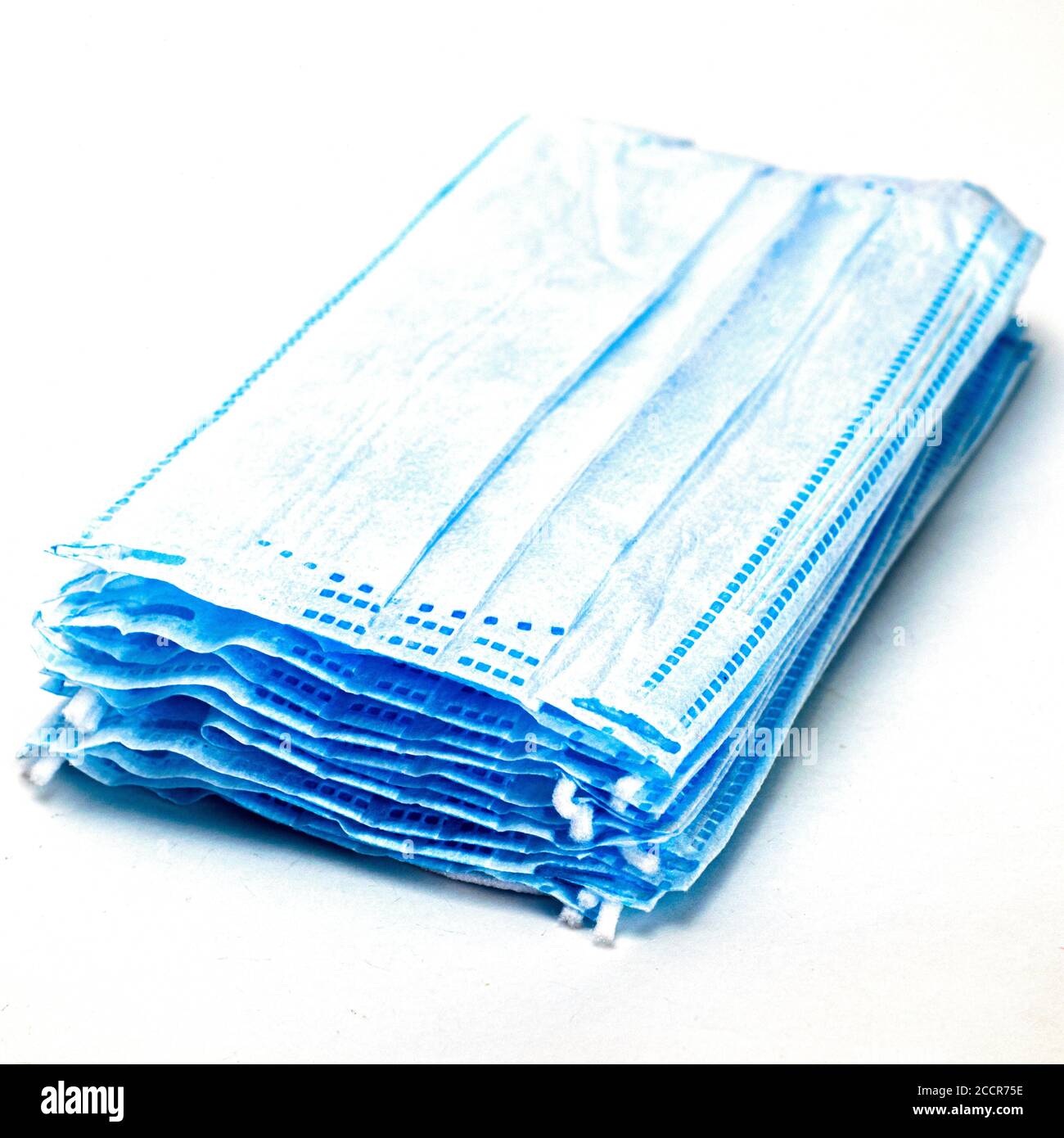 stack of medical hygiene masks on a white background Stock Photo - Alamy