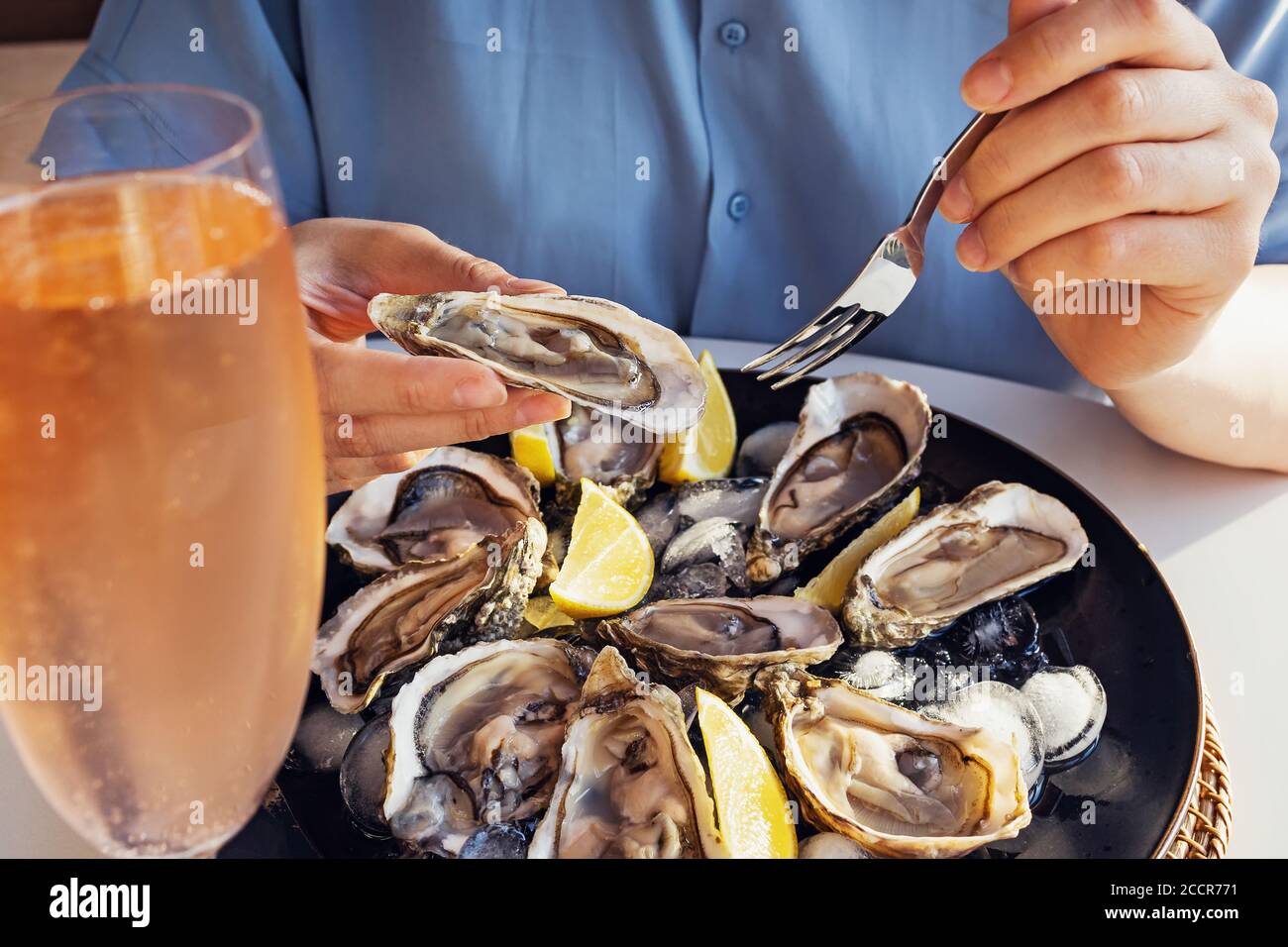 Person eating oysters restaurant hi-res stock photography and images ...