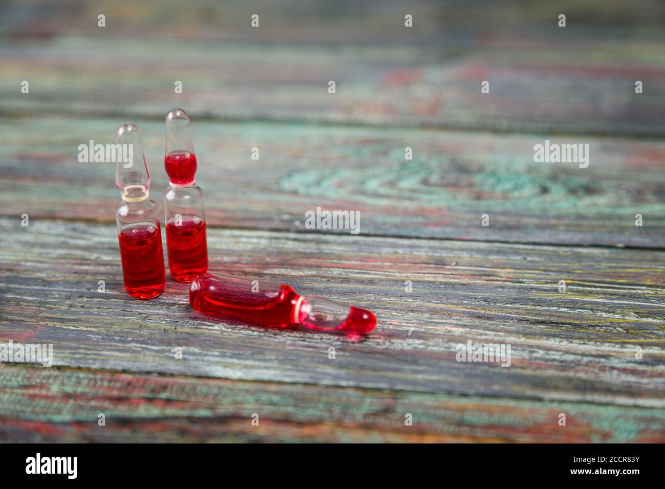 Injection bottle on wooden background Stock Photo - Alamy