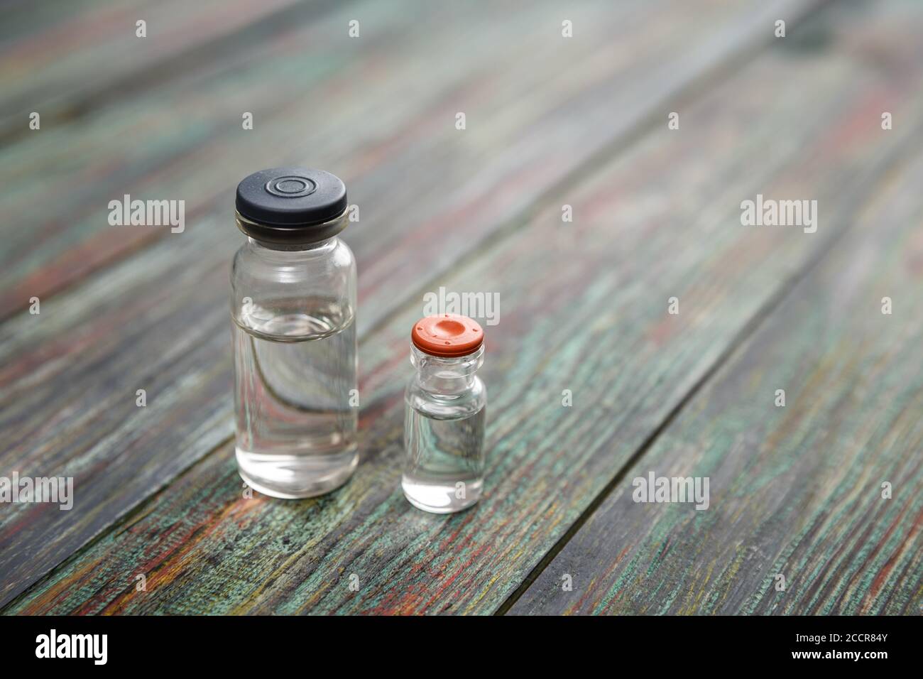 Injection bottle on wooden background Stock Photo - Alamy