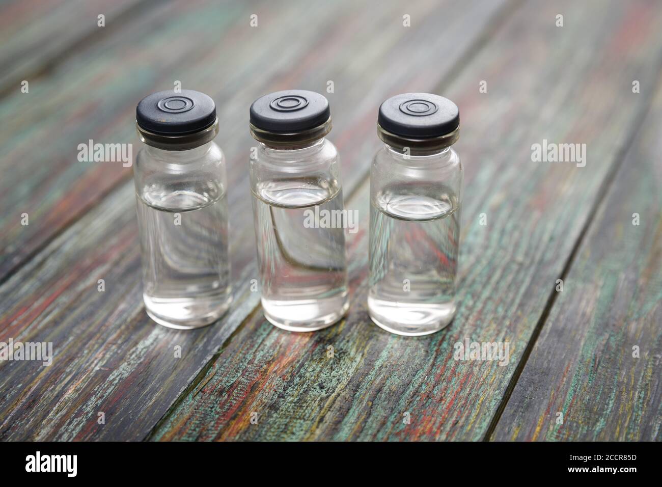 Injection bottle on wooden background Stock Photo - Alamy