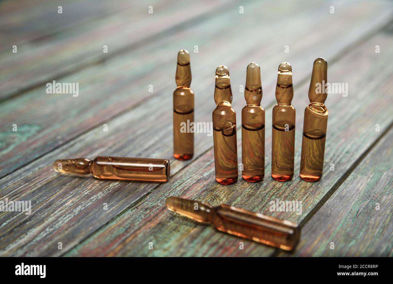 Injection bottle on wooden background Stock Photo - Alamy