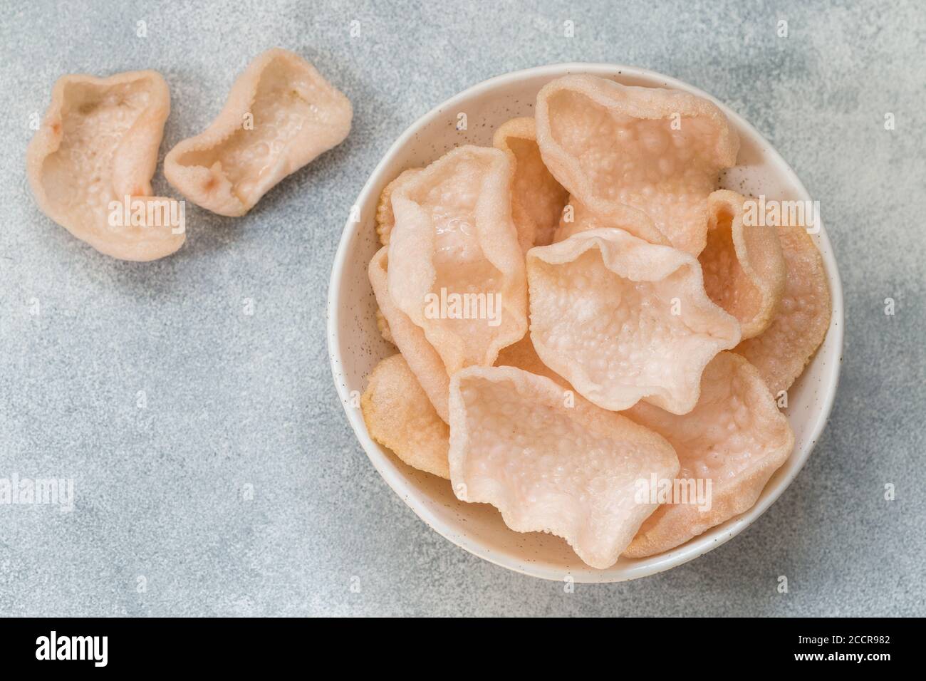 Delicious crispy chips made of starch, flour and shrimp. Bowl of Krupuk ...