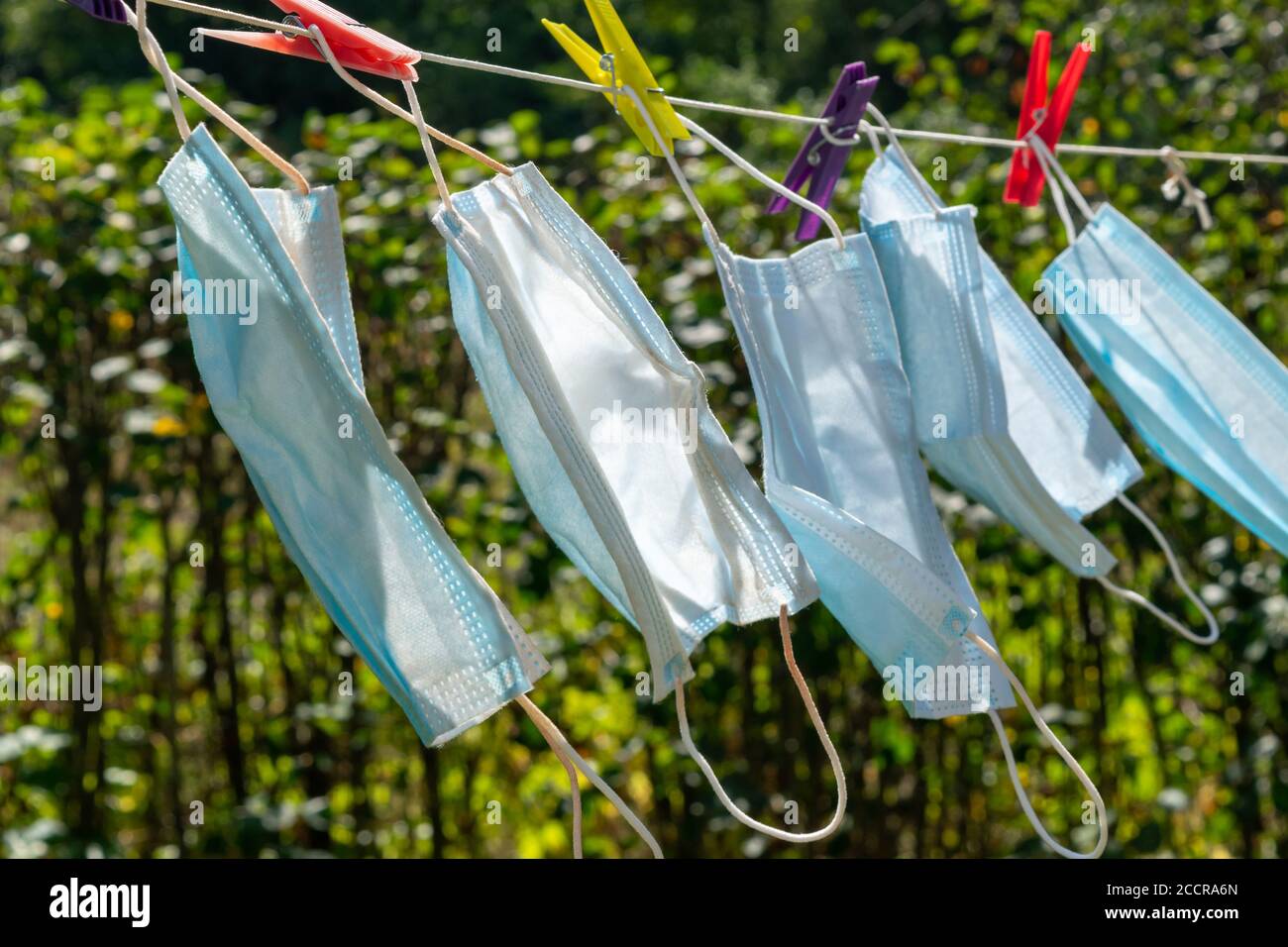 Masks hanging in bush hi-res stock photography and images - Alamy
