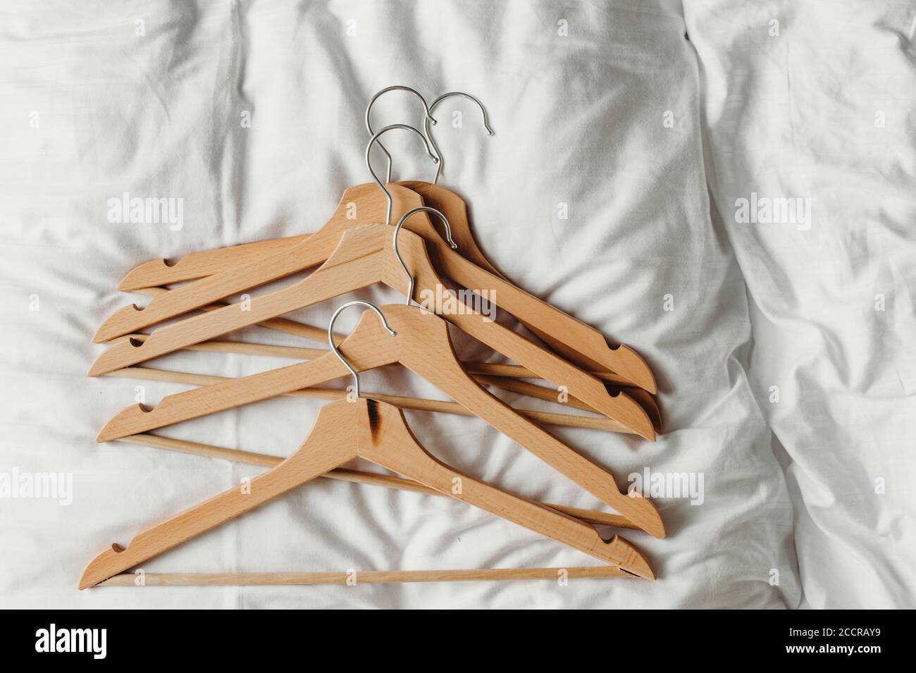 Many wooden clothes hanger. Trempel on a on light background. Store ...