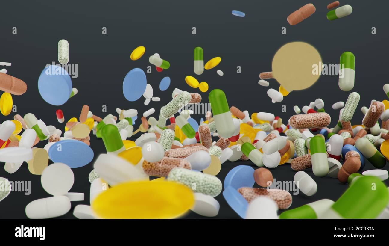Falling different colored tablets, capsules on black background. Health ...