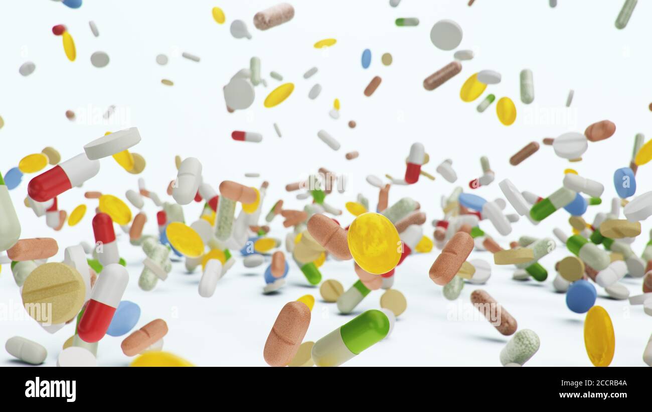 Falling different colored tablets, capsules on white background. Health ...