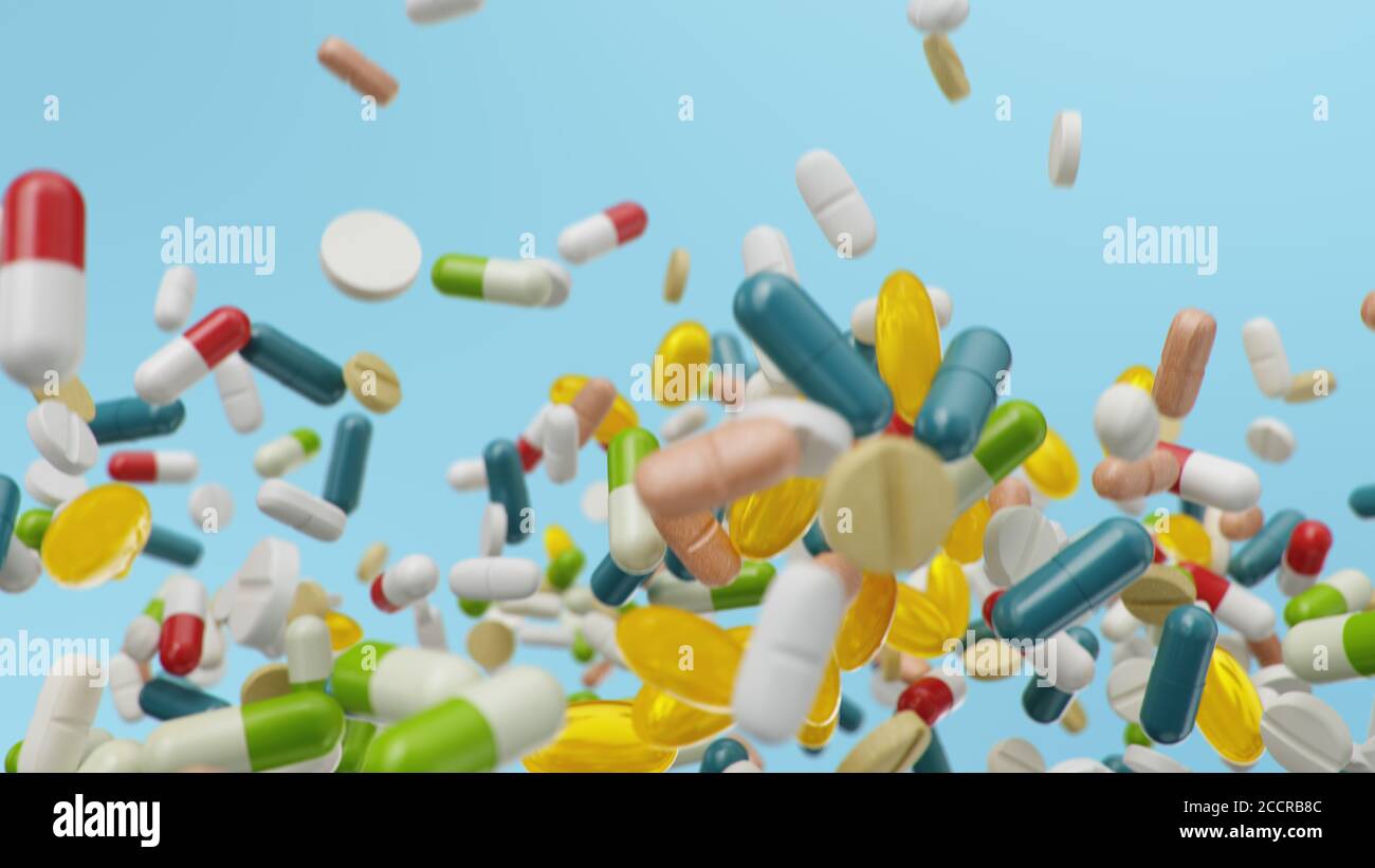 Flying, falling pills. different colored tablets, capsules. Health care ...