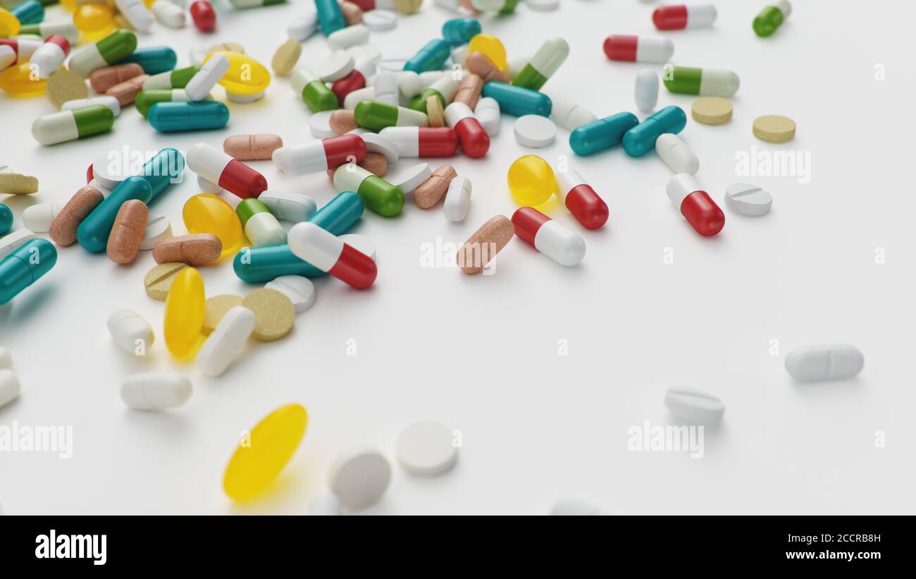 Many different colored tablets, capsules isolate on white background ...