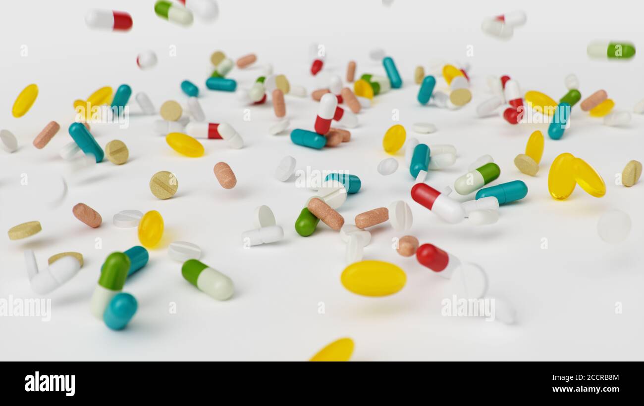 Many different colored tablets, capsules isolate on white background ...