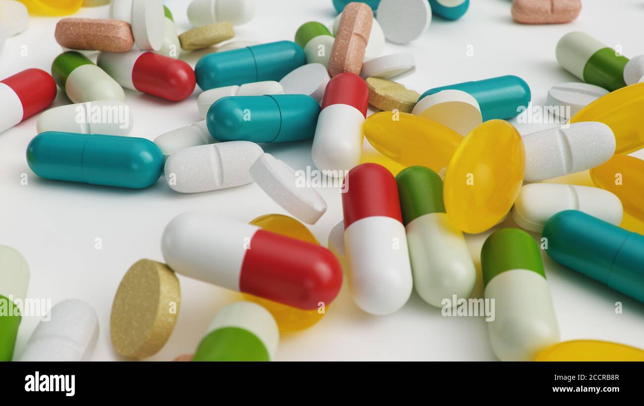 Many different colored tablets, capsules isolate on white background ...