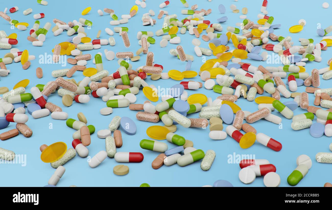Many different colored tablets, capsules on blue background. Health ...