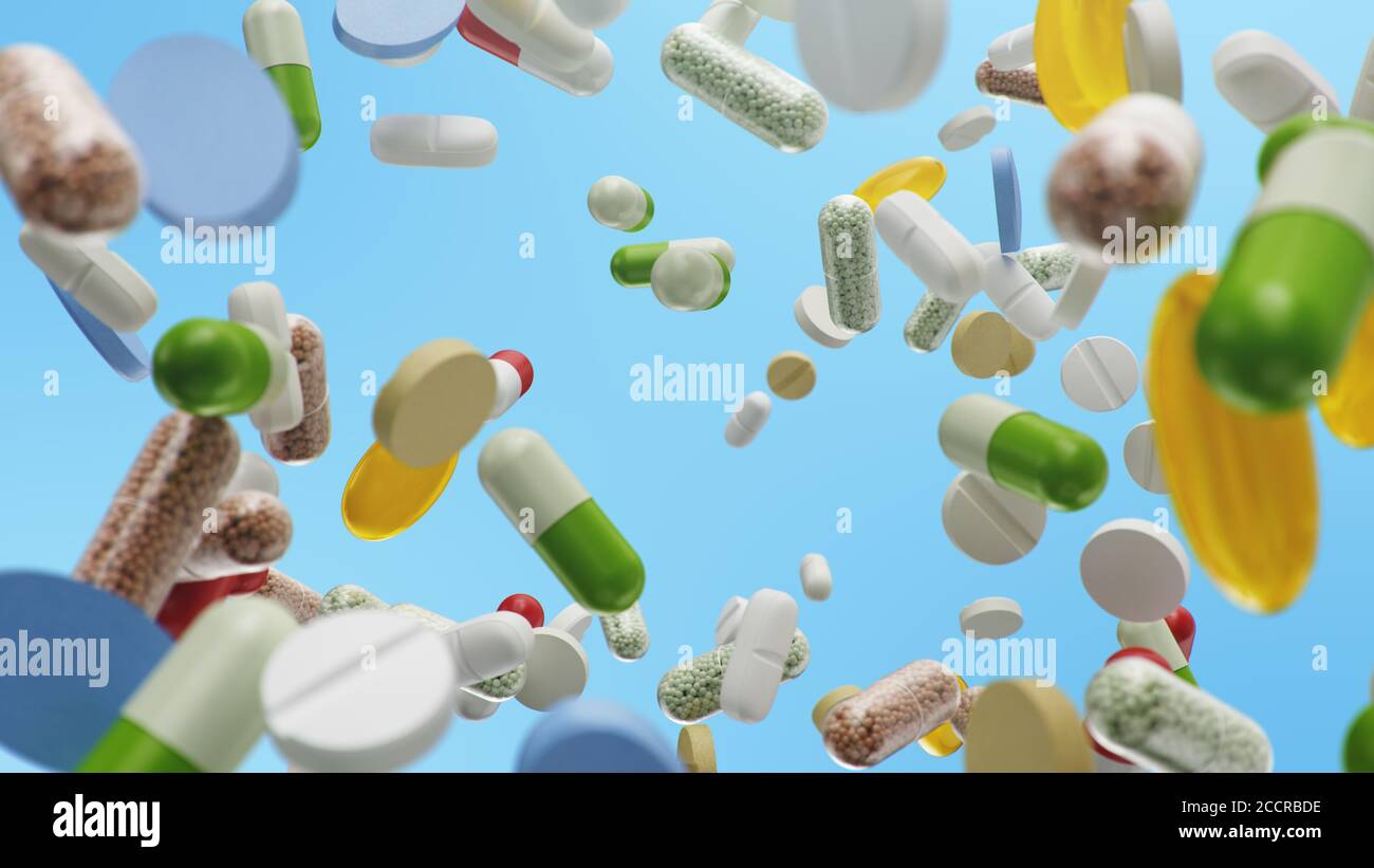 Flying, falling pills. different colored tablets, capsules. Health care ...