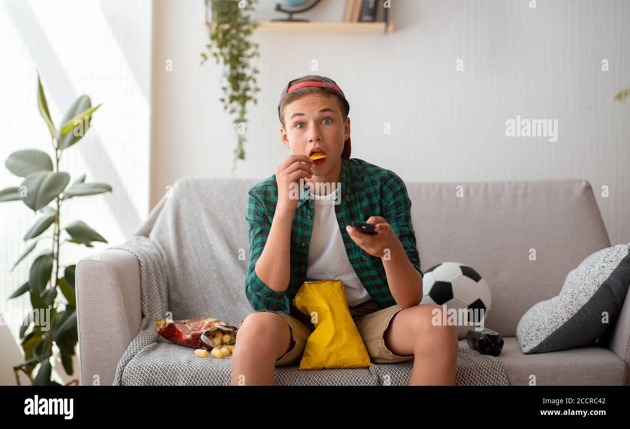 Surprised teenager football fan watching game on tv Stock Photo - Alamy