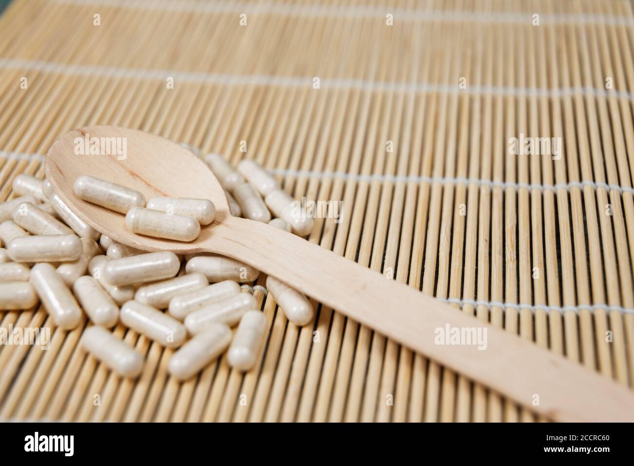 Alternative medicine tablets on a wooden spoon Stock Photo - Alamy