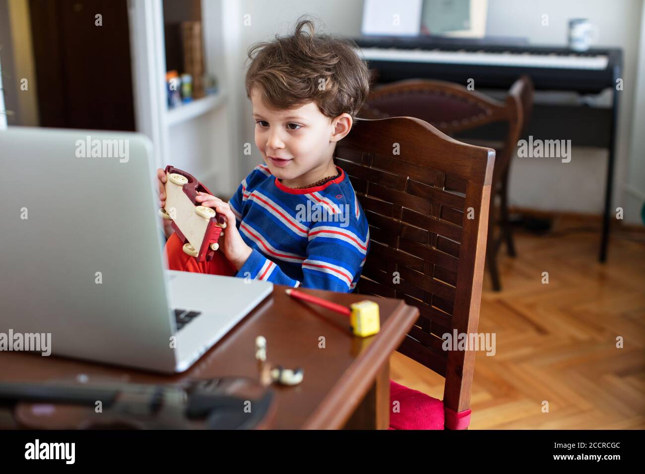 Little Child Smiling and Staring at the Computer during an Online Chat ...