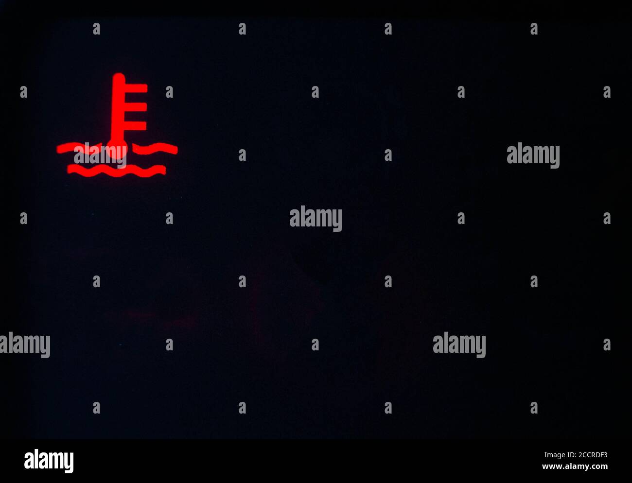Red indicator of car engine coolant on a black background. Car ...