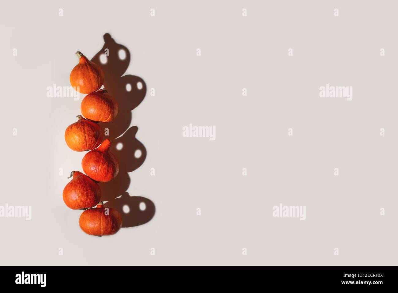 A pyramid of orange pumpkins with funny ghost shadows with eyes ...