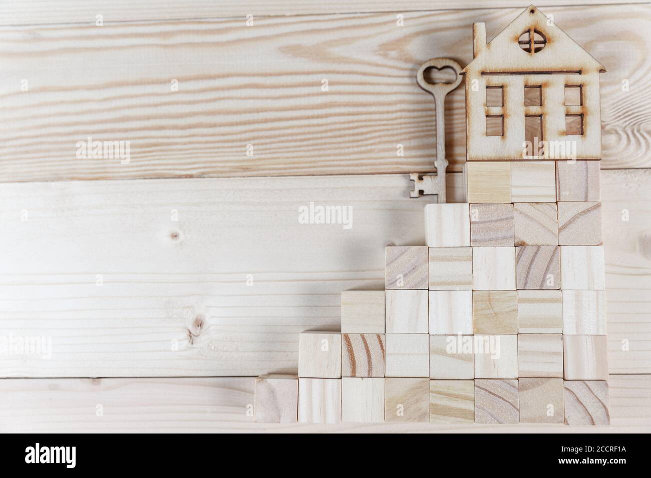 Real estate concept. Small toy wooden house with keys Stock Photo - Alamy