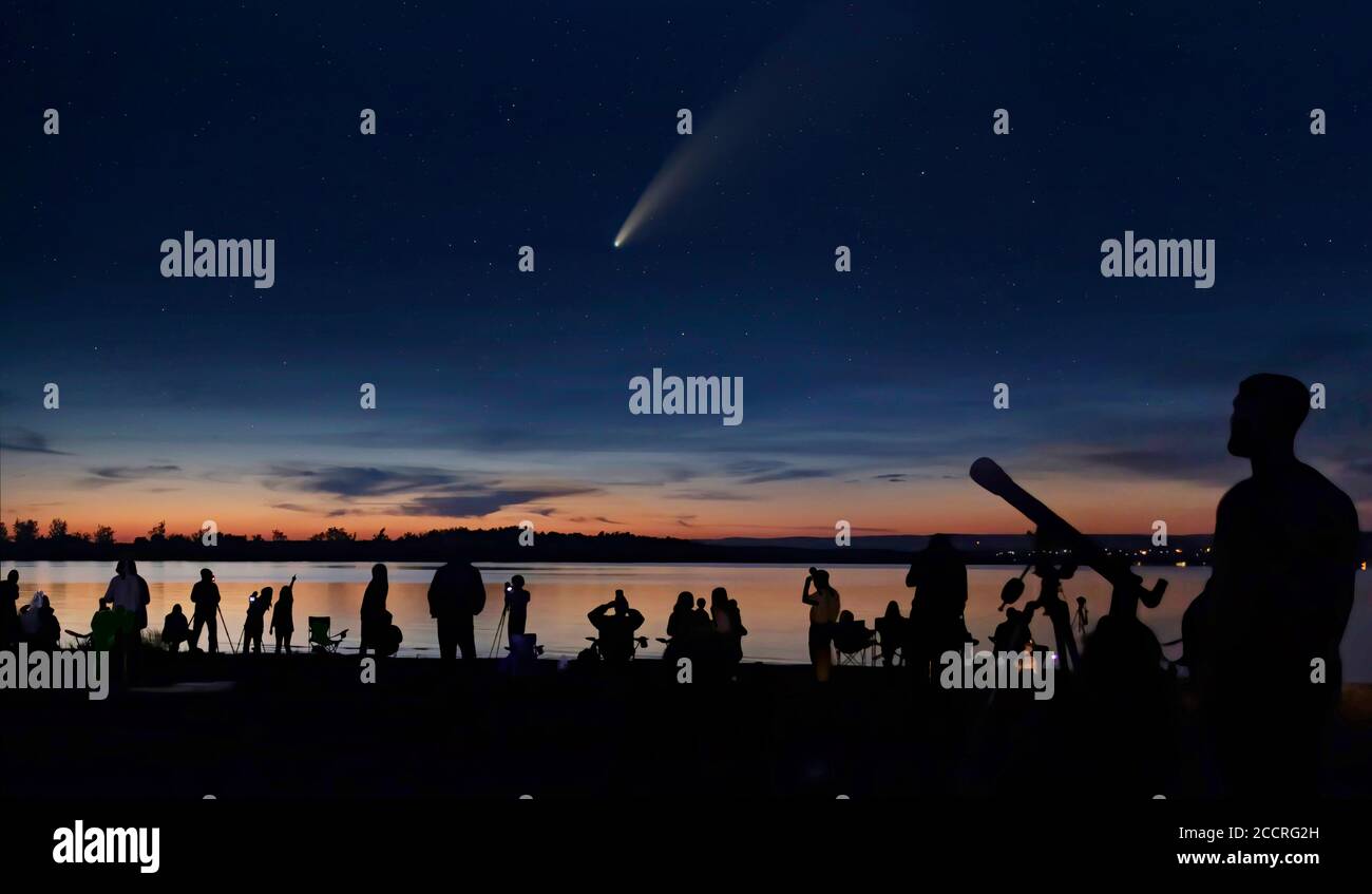 Comet Neowise and people with cameras and telescope silhouetted by the ...
