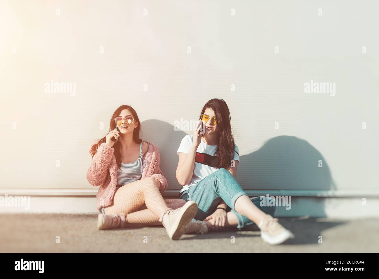 Two women using mobile phones hi-res stock photography and images - Alamy