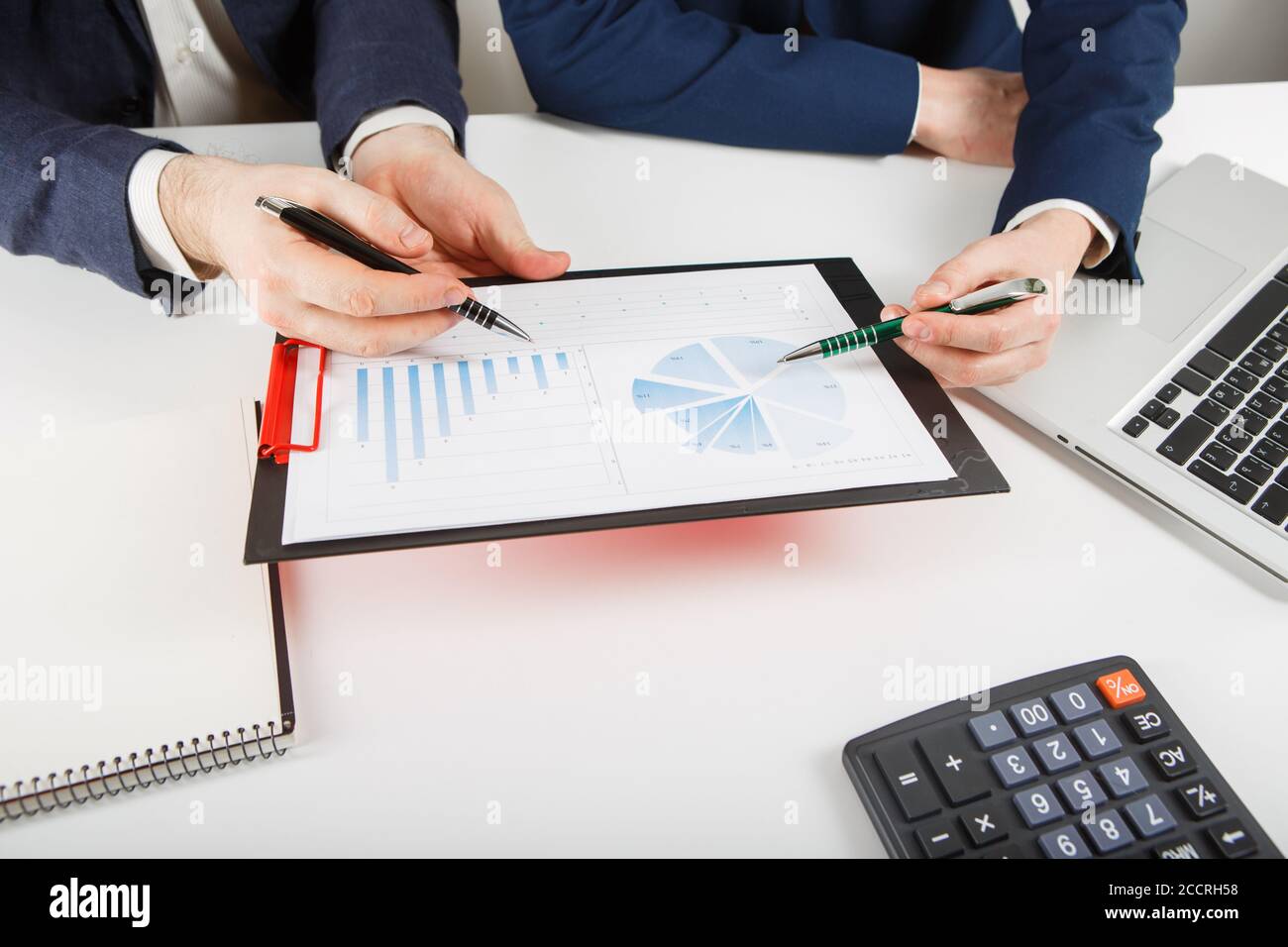 Business people discussing the charts and graphs showing Stock Photo ...