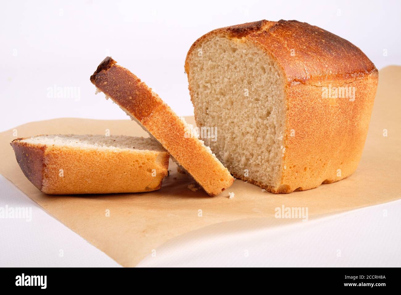 bakery products, freshly baked wheat bread, sliced bread on parchment ...