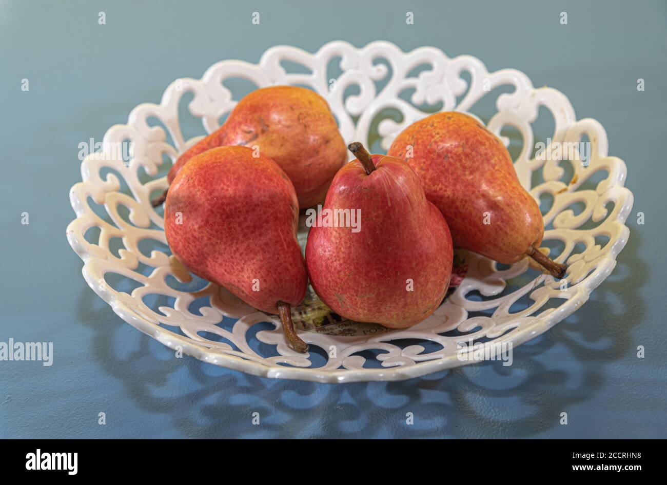 Pyrus comunis l. Red fruits. Fresh fruits on blue background and white ...