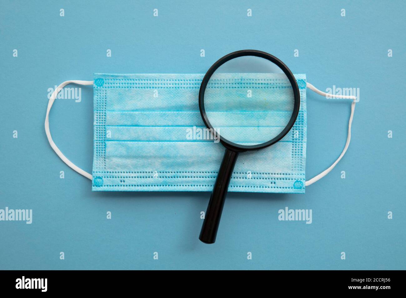 Medical research concept. Medical face mask with a magnifying glass ...